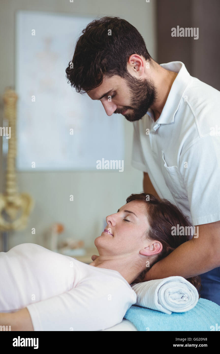Physiotherapist giving neck massage to a woman Stock Photo - Alamy