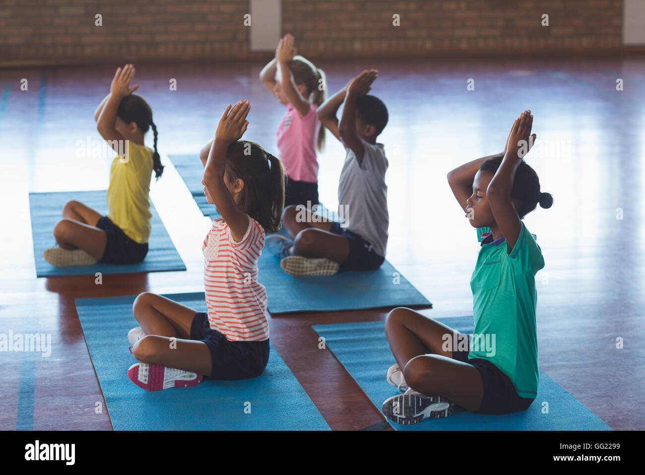 School kids meditating during yoga class Stock Photo - Alamy