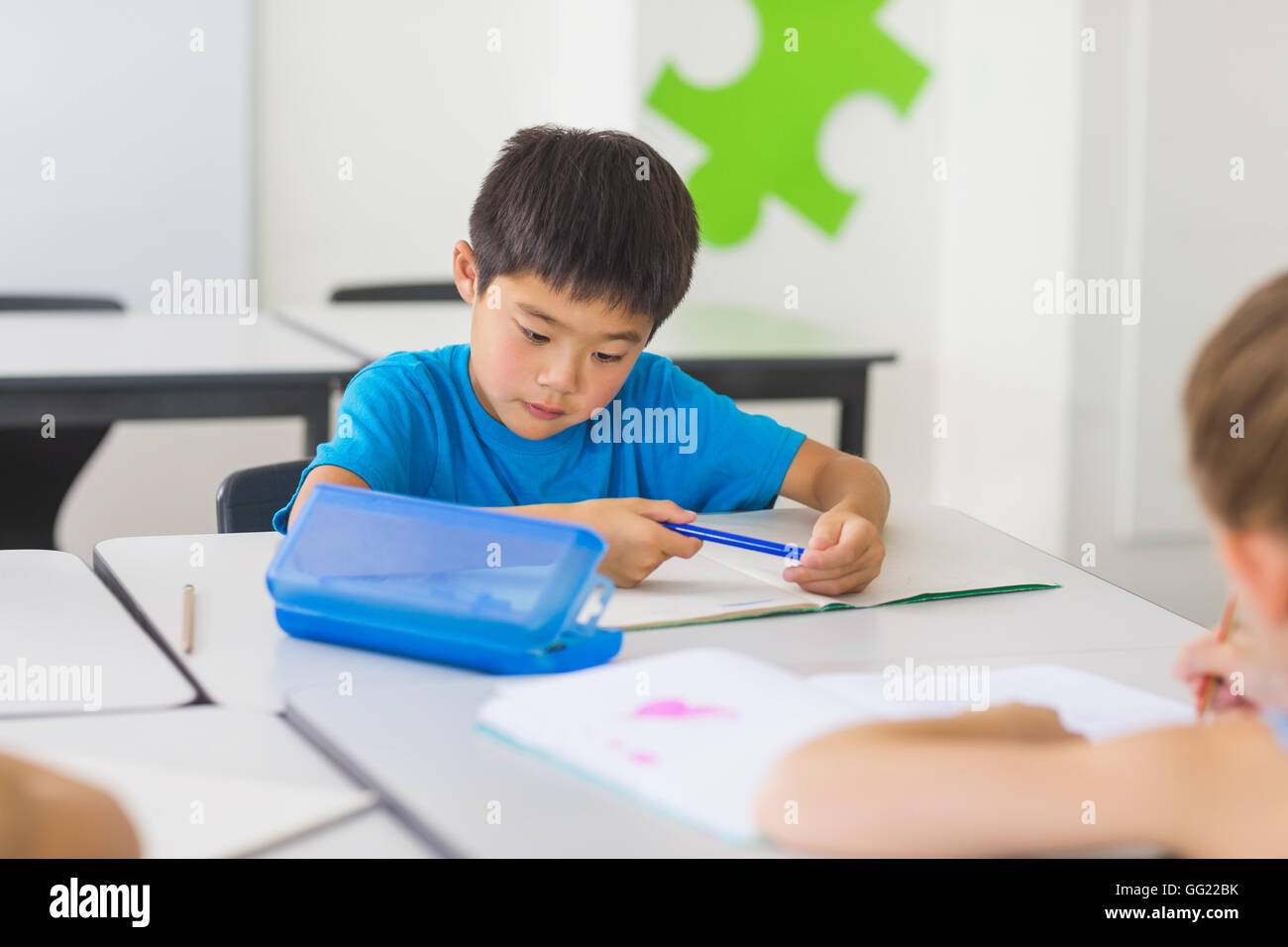 Schoolboy studying in classroom Stock Photo - Alamy
