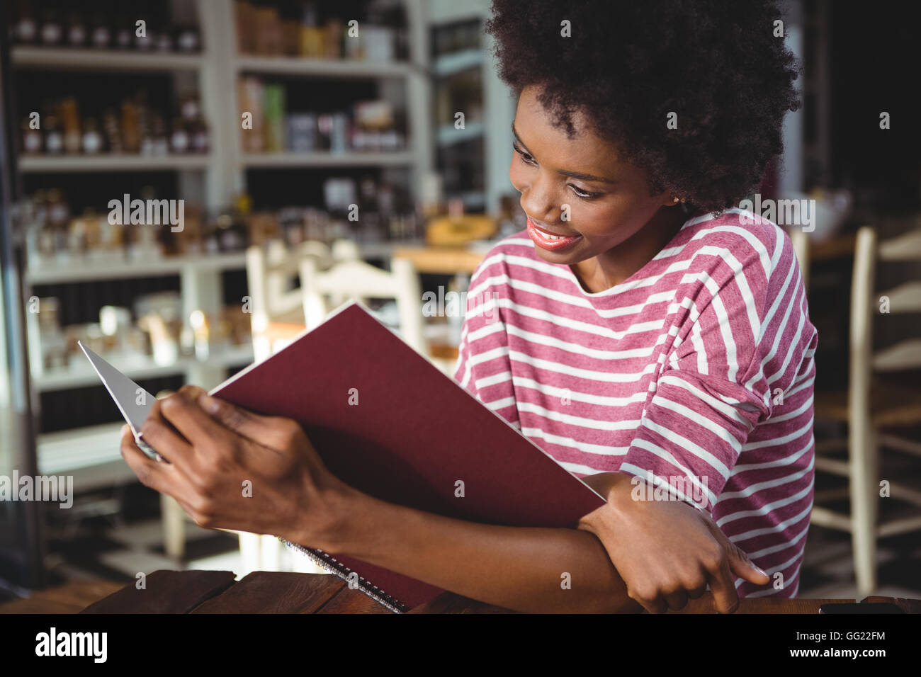 Young woman reading menu sitting hi-res stock photography and images ...