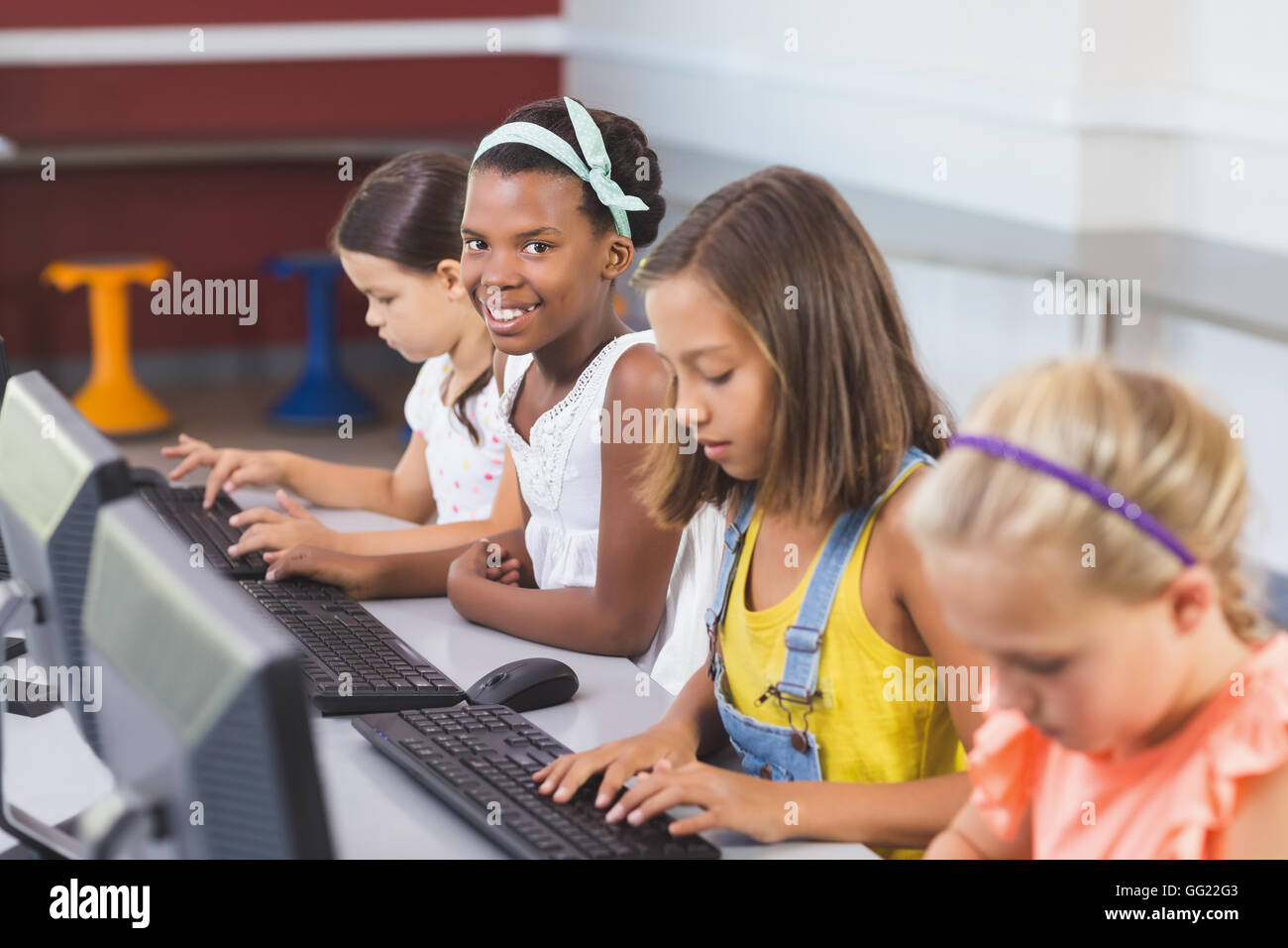 Schoolgirls using computer in classroom Stock Photo - Alamy
