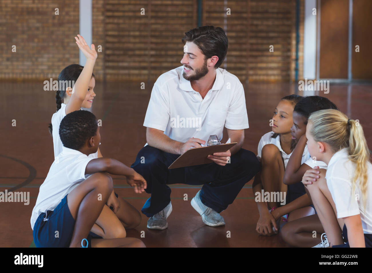 Sports teacher having discussion with his students Stock Photo - Alamy