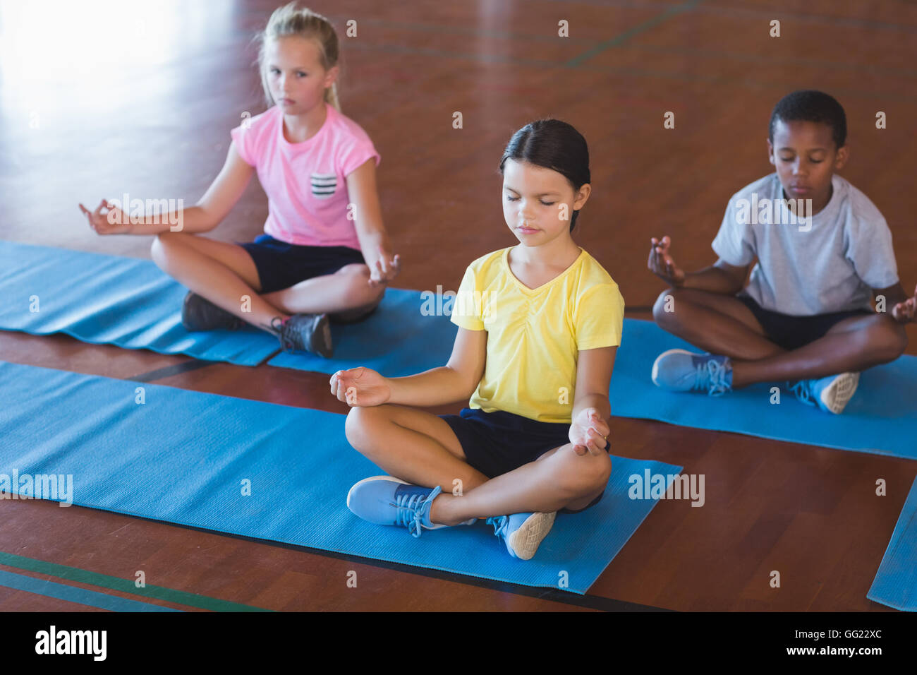 School kids meditating during yoga class Stock Photo - Alamy