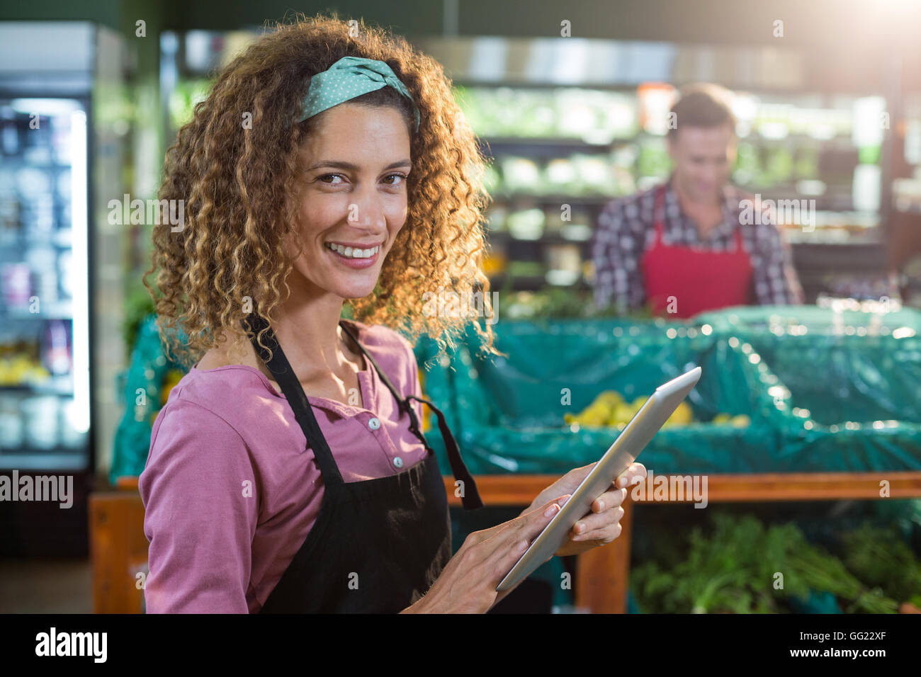 Female staff using digital tablet in organic section Stock Photo - Alamy