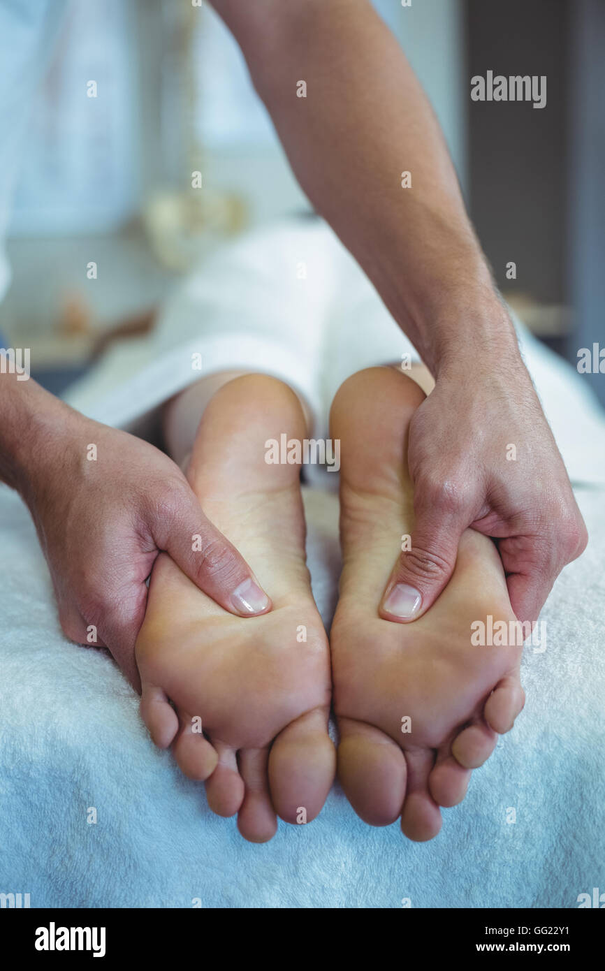 Physiotherapist giving foot massage to a woman Stock Photo - Alamy