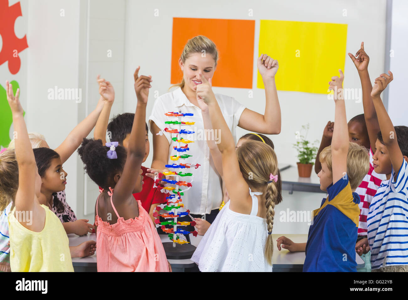 Teacher assisting kids in laboratory Stock Photo - Alamy