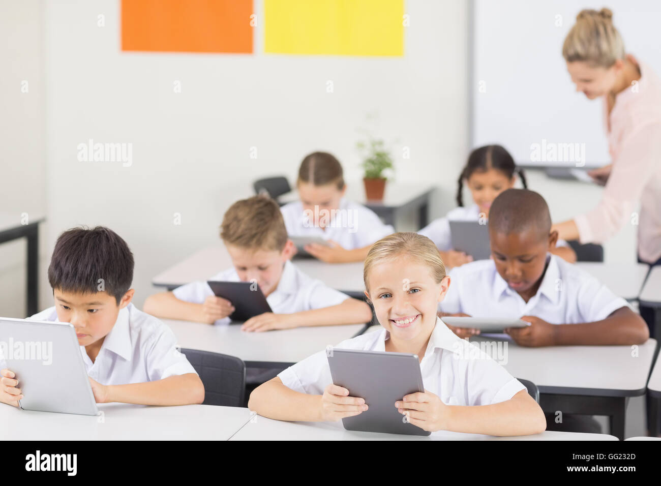 Students using digital tablet in classroom Stock Photo - Alamy