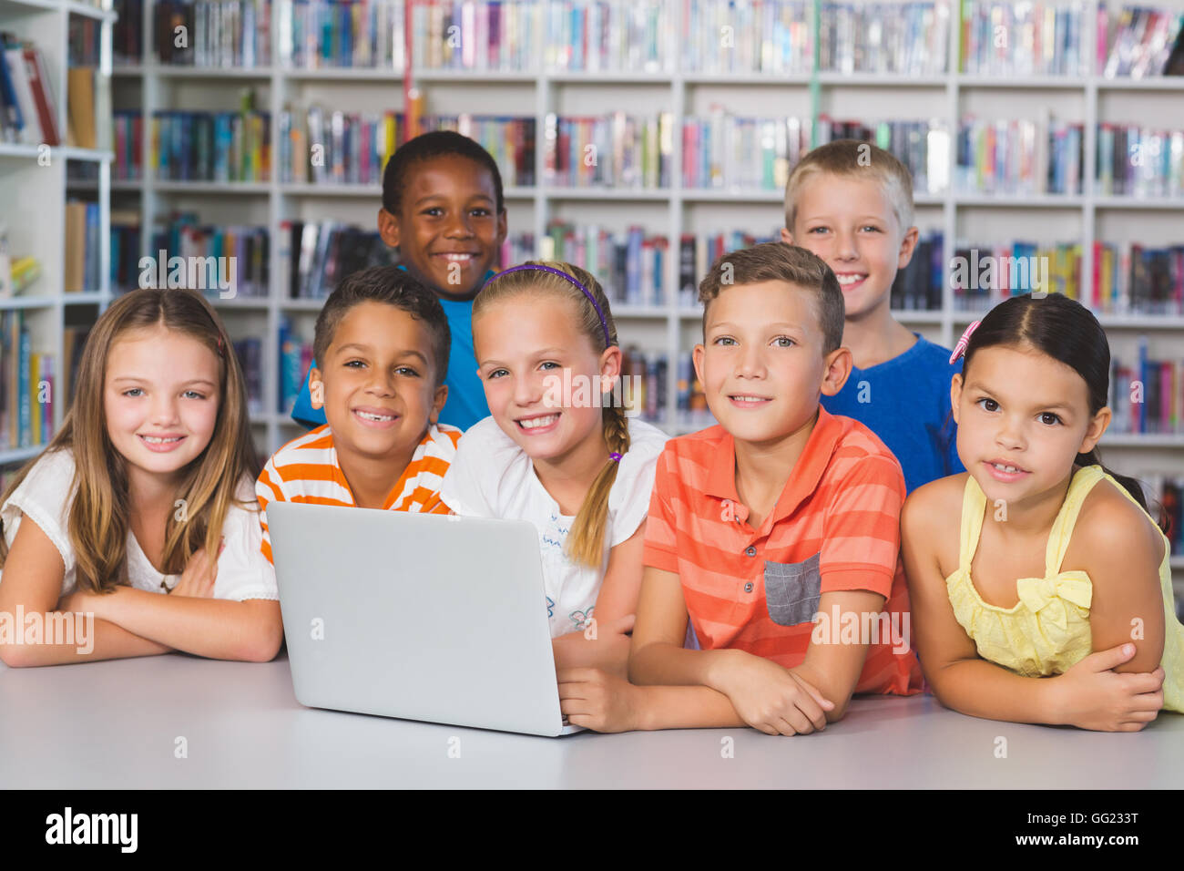 Portrait of school kids using laptop in library Stock Photo - Alamy