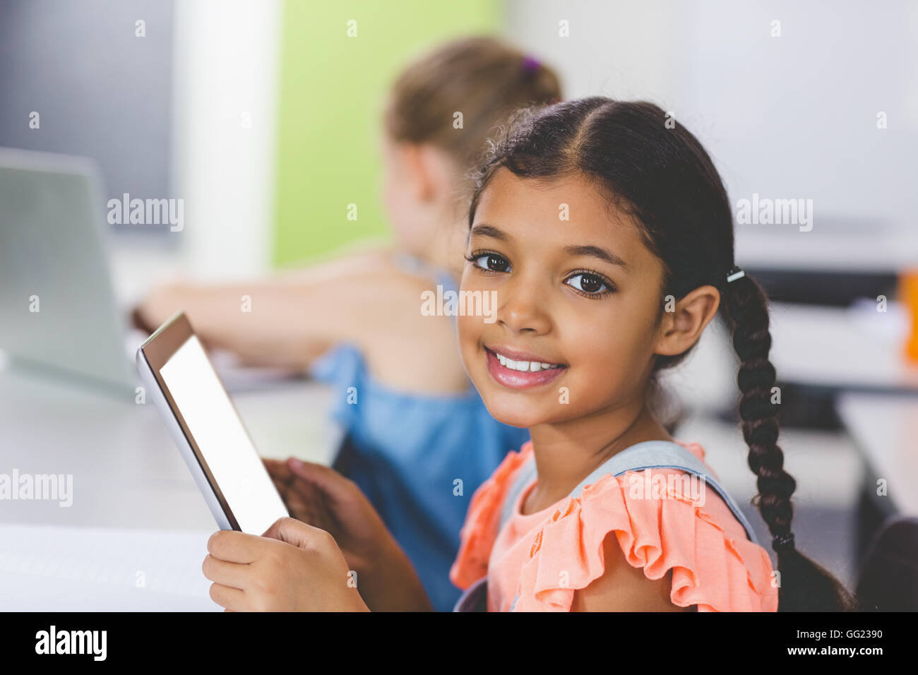 Schoolgirl using digital tablet in classroom Stock Photo - Alamy