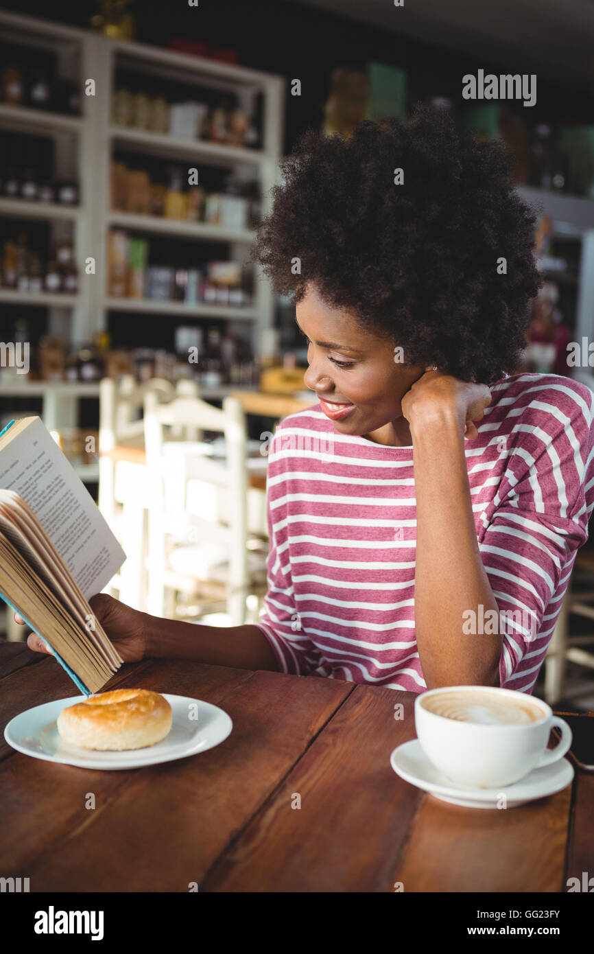 Woman reading book cafe hi-res stock photography and images - Alamy