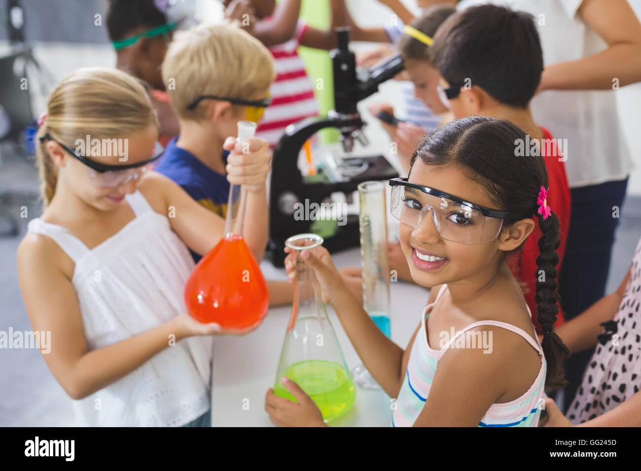 Kids doing a chemical experiment in laboratory Stock Photo - Alamy
