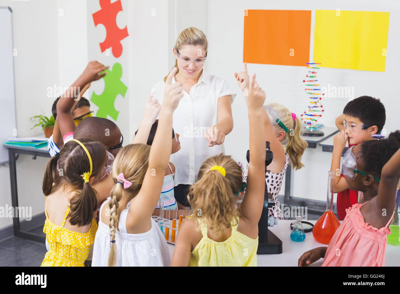 Kids raising hands in class hi-res stock photography and images - Alamy