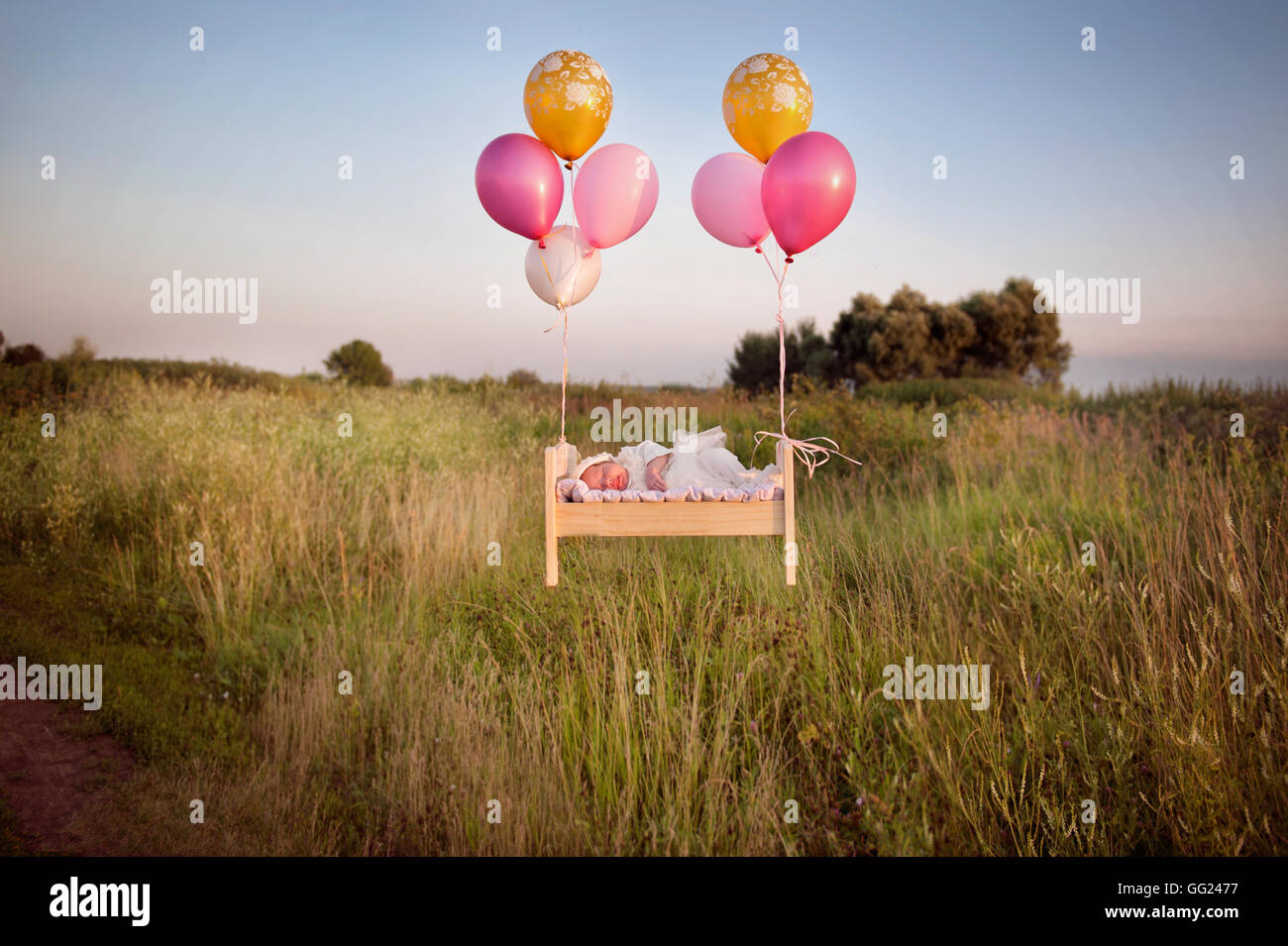 A tiny baby asleep in his crib in lace bonnet A tiny baby asleep in his ...