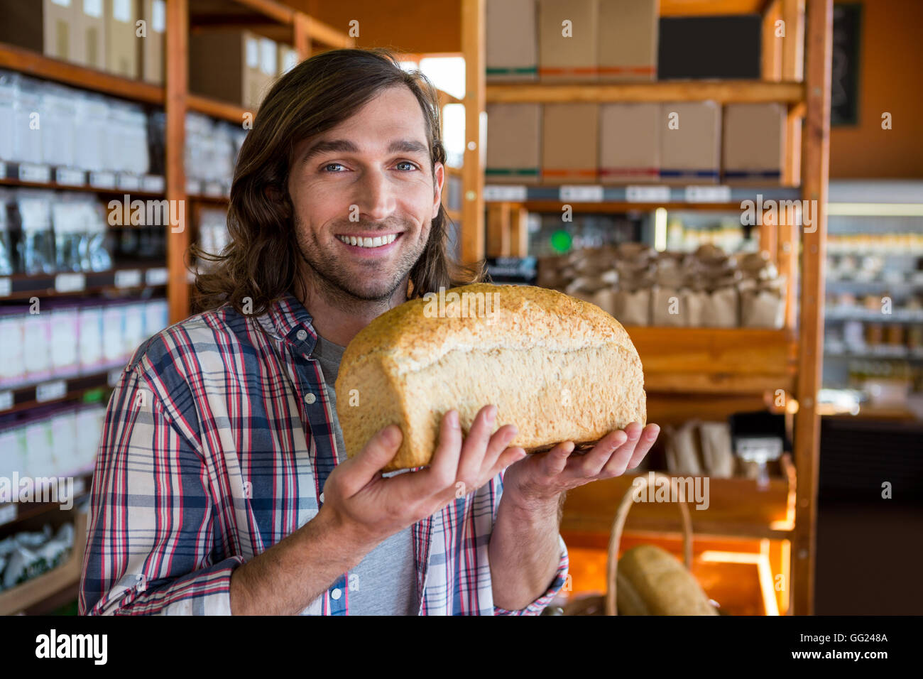 Man holding a loaf of bread Stock Photo - Alamy
