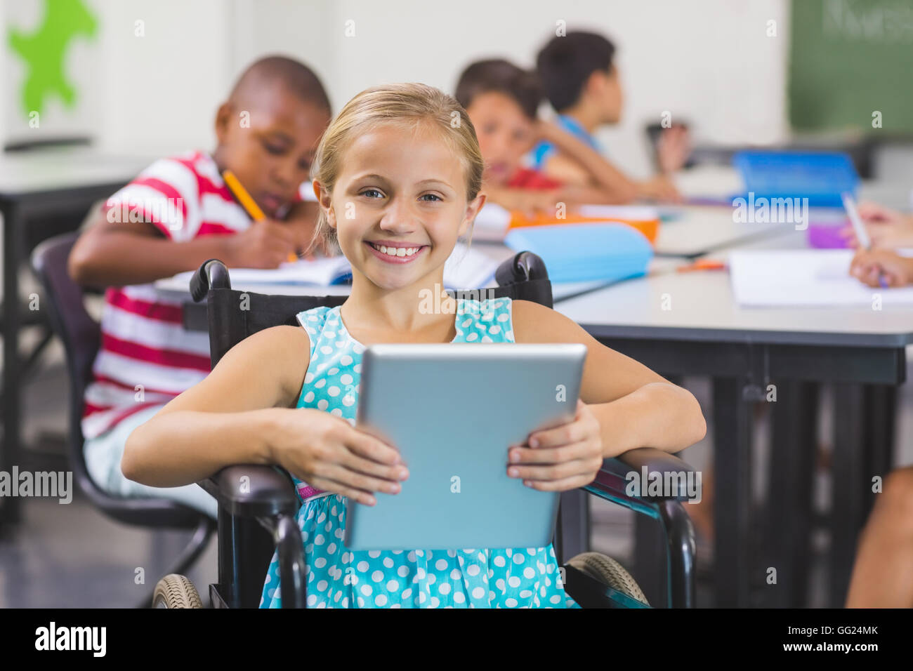Disabled schoolgirl using digital tablet Stock Photo - Alamy