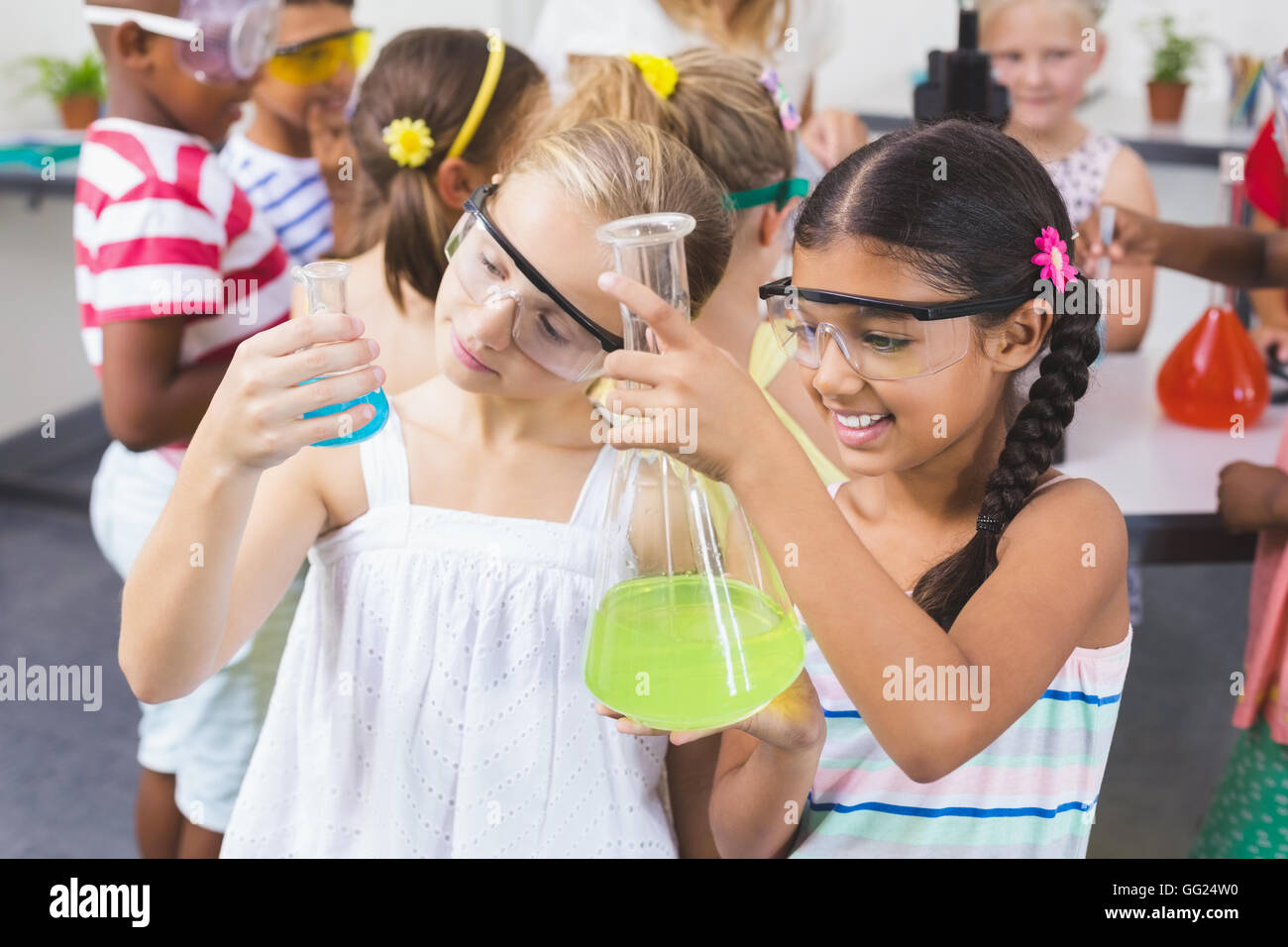 Kids doing a chemical experiment in laboratory Stock Photo - Alamy
