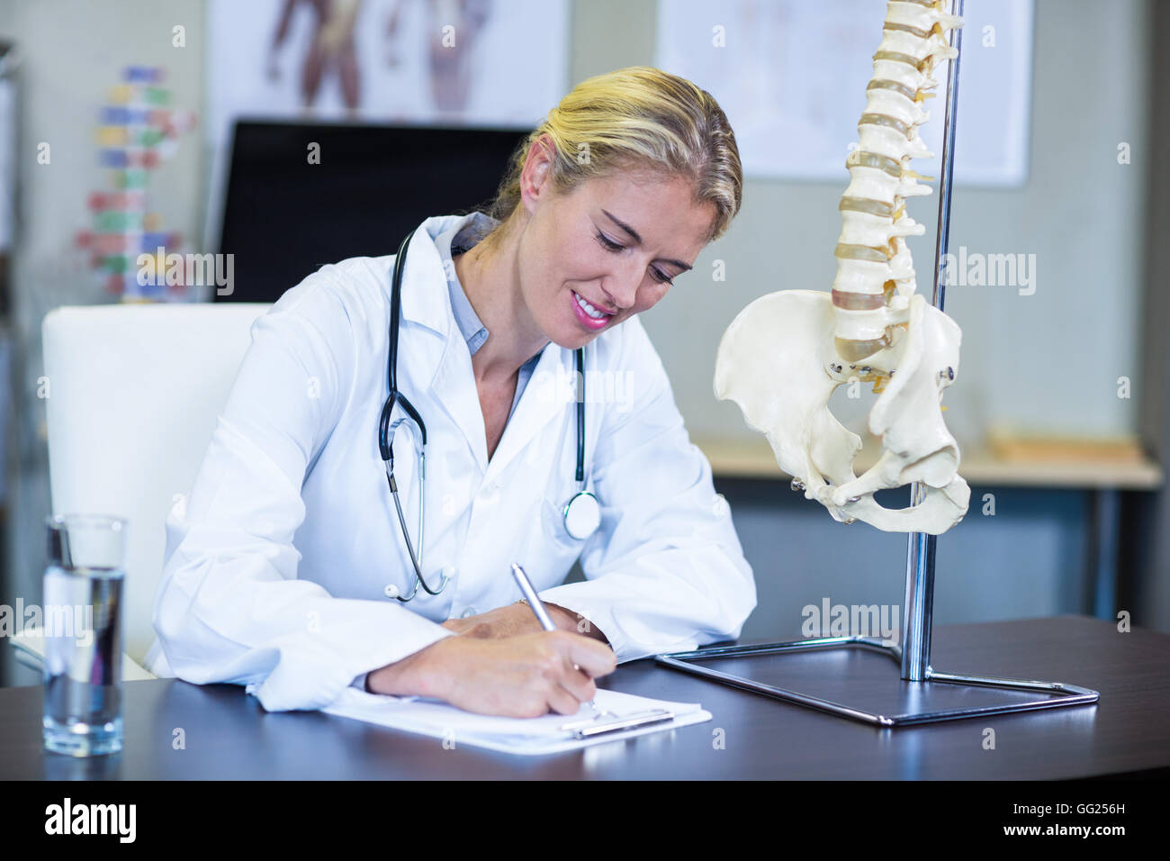 Physiotherapist writing a report Stock Photo - Alamy