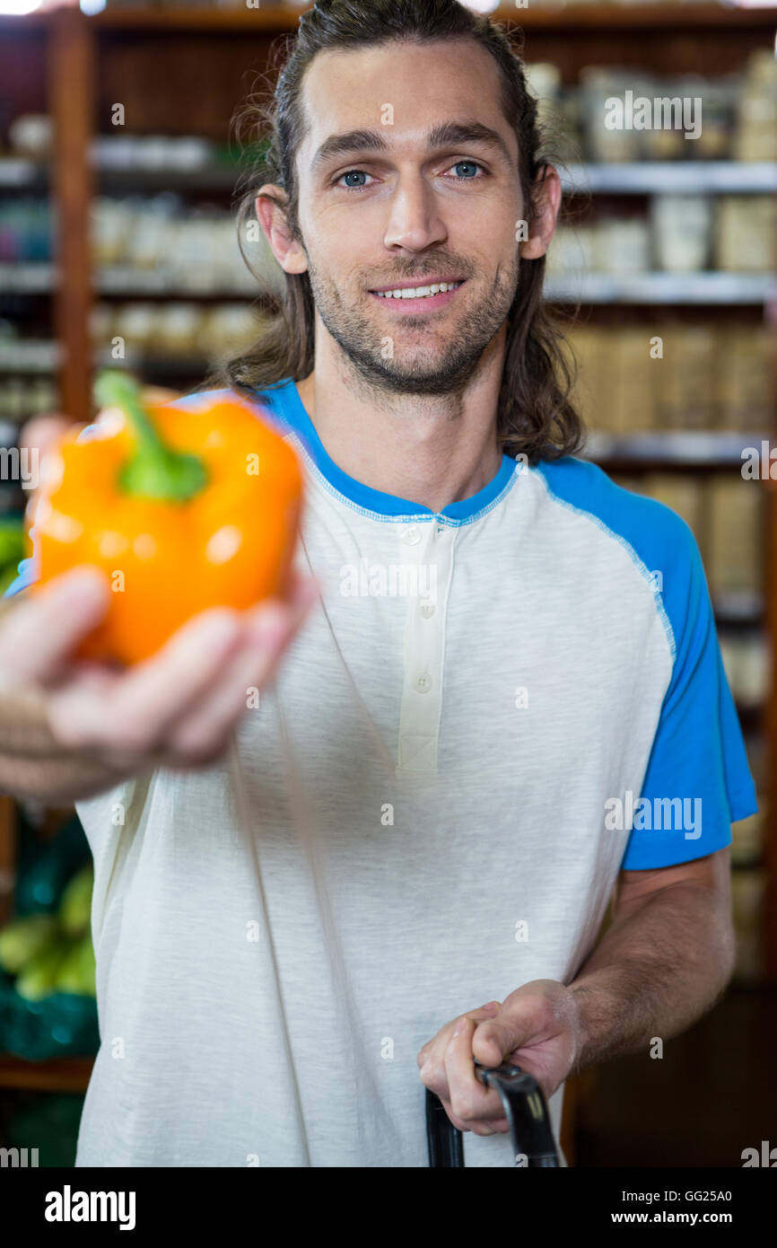 Man holding bell pepper Stock Photo - Alamy