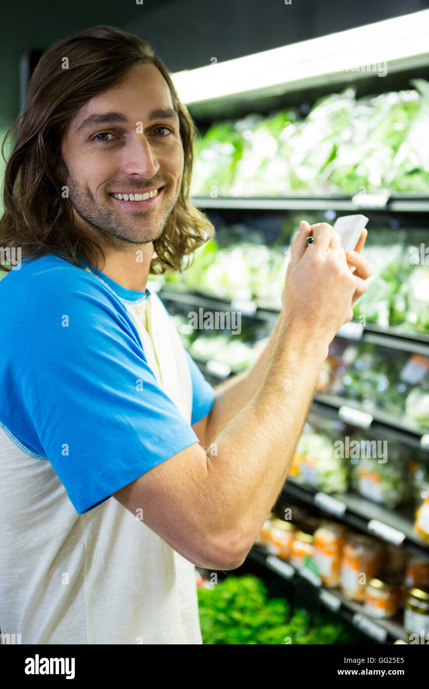 Man ticking on shopping checklist Stock Photo - Alamy