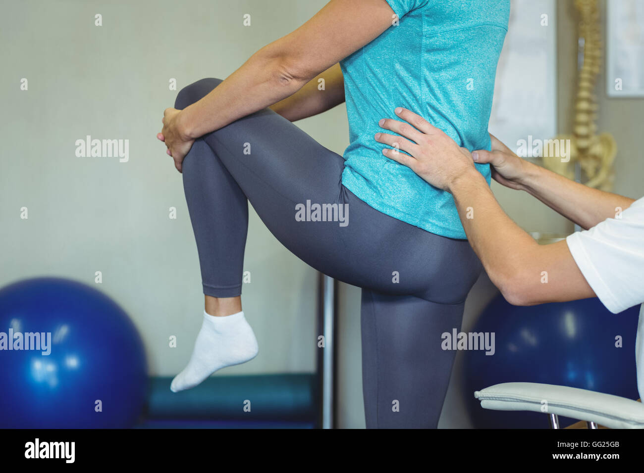 Physiotherapist examining womans back Stock Photo - Alamy