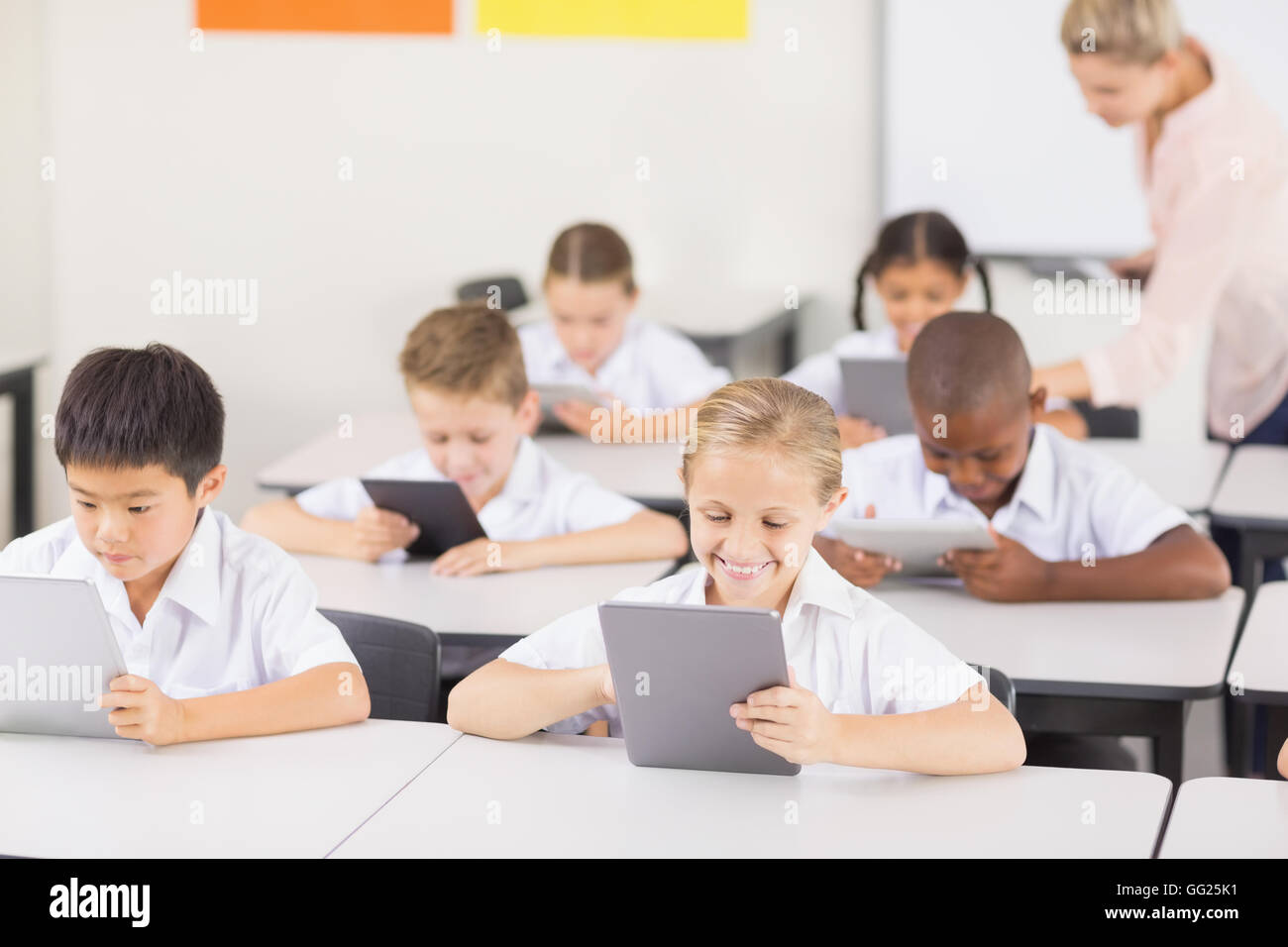Students using digital tablet in classroom Stock Photo - Alamy