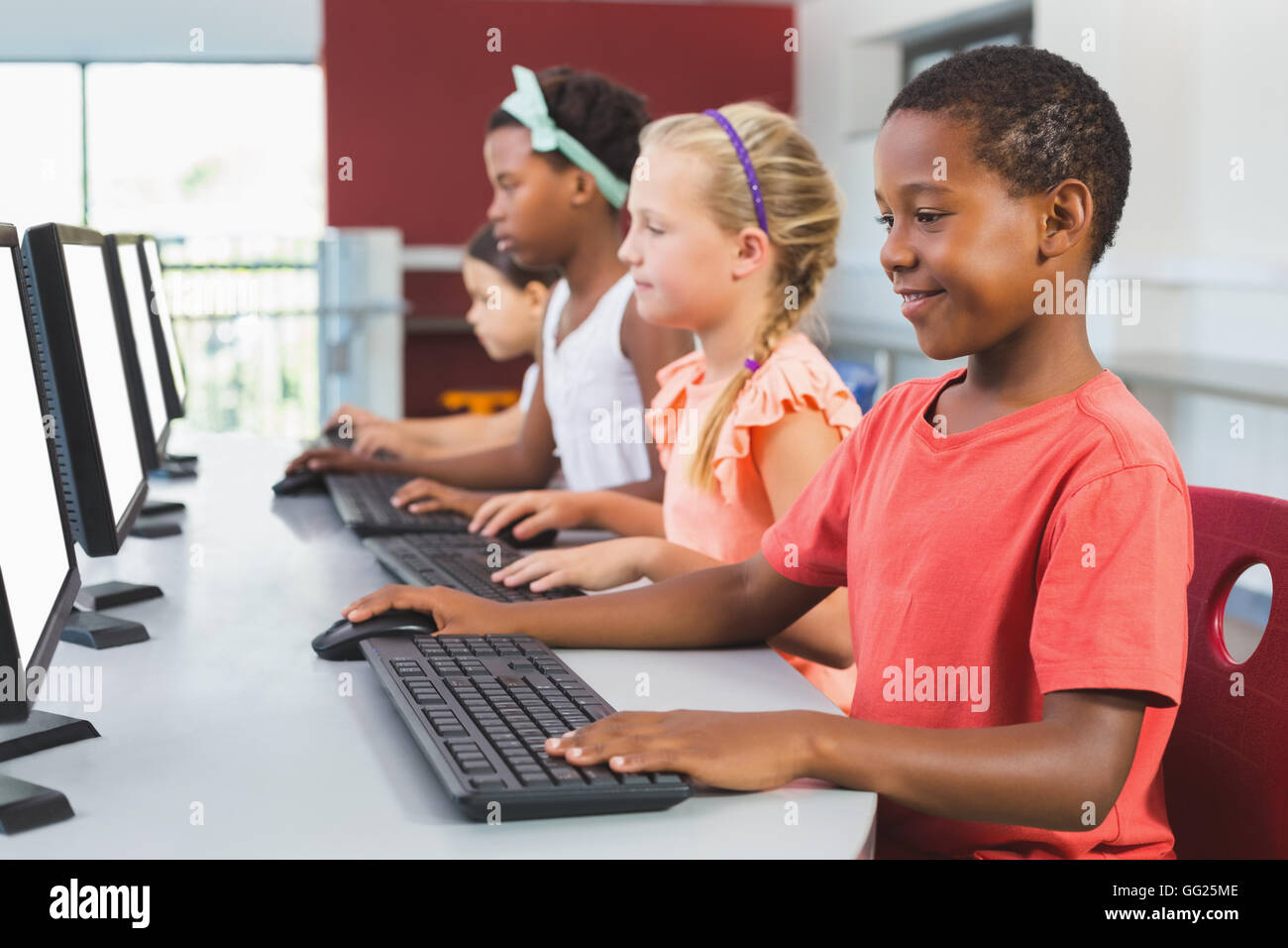 School kids using computer in classroom Stock Photo - Alamy