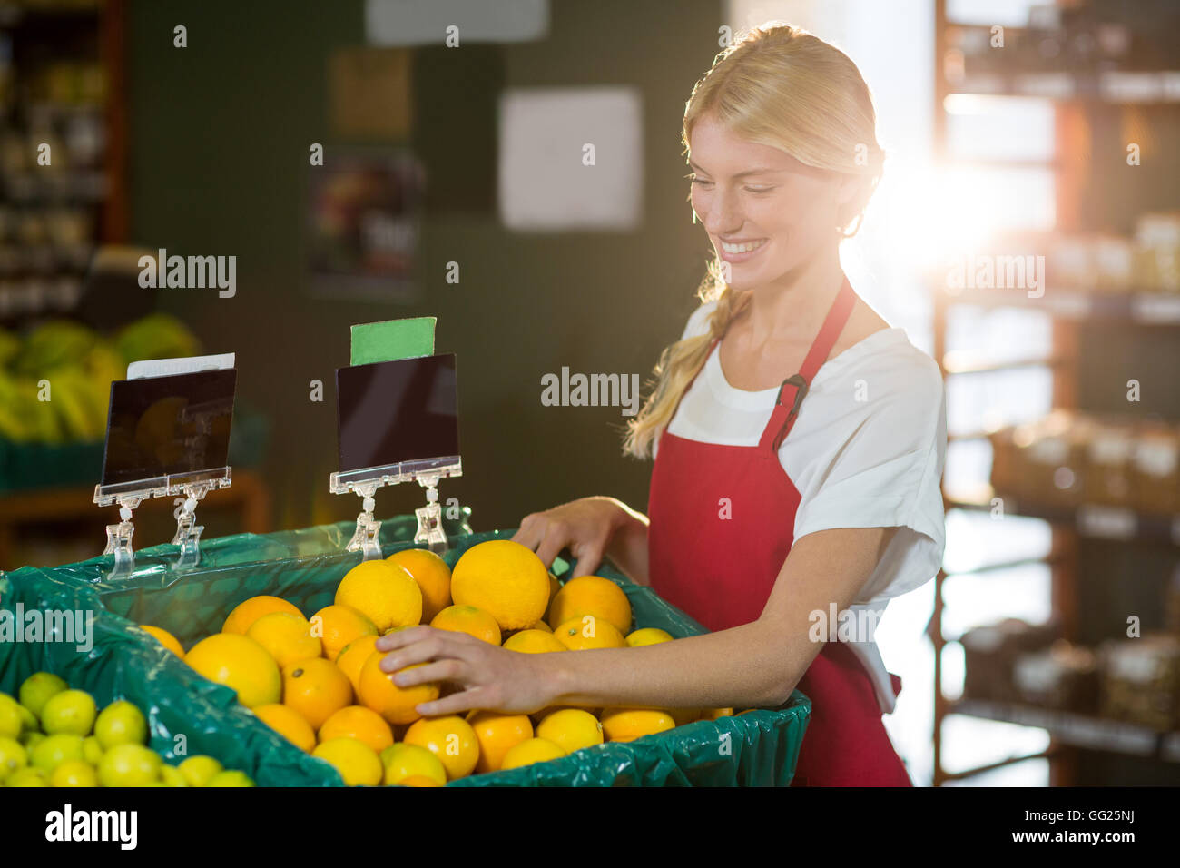Female staff checking fruits in organic section Stock Photo - Alamy