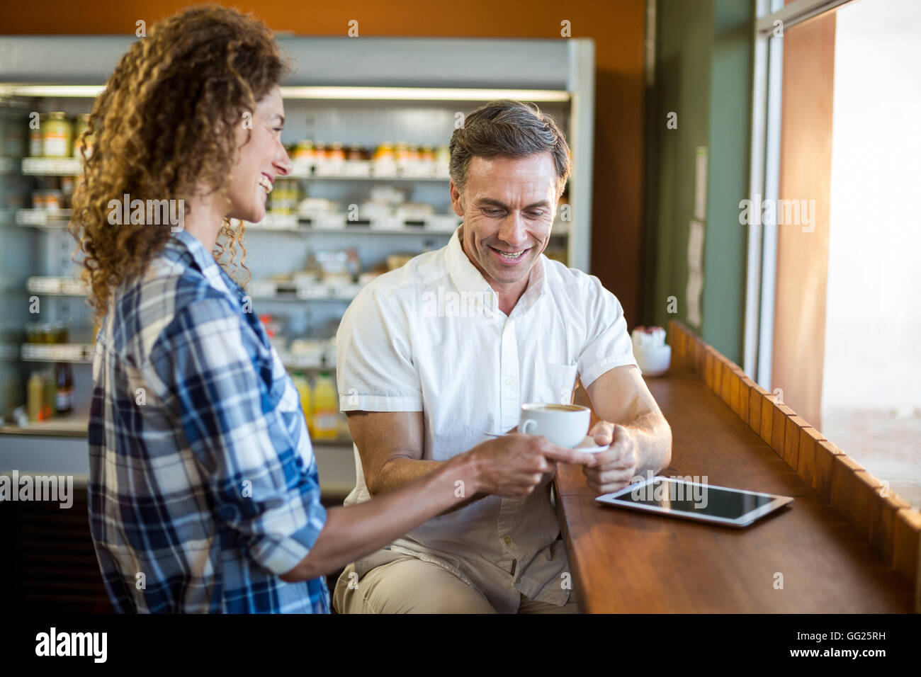 Mature woman coffee interacting tablet hi-res stock photography and ...