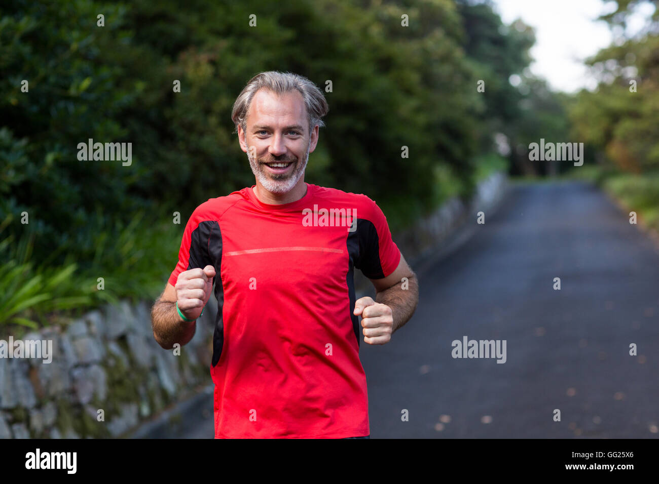 Athletic man jogging on the open road Stock Photo - Alamy