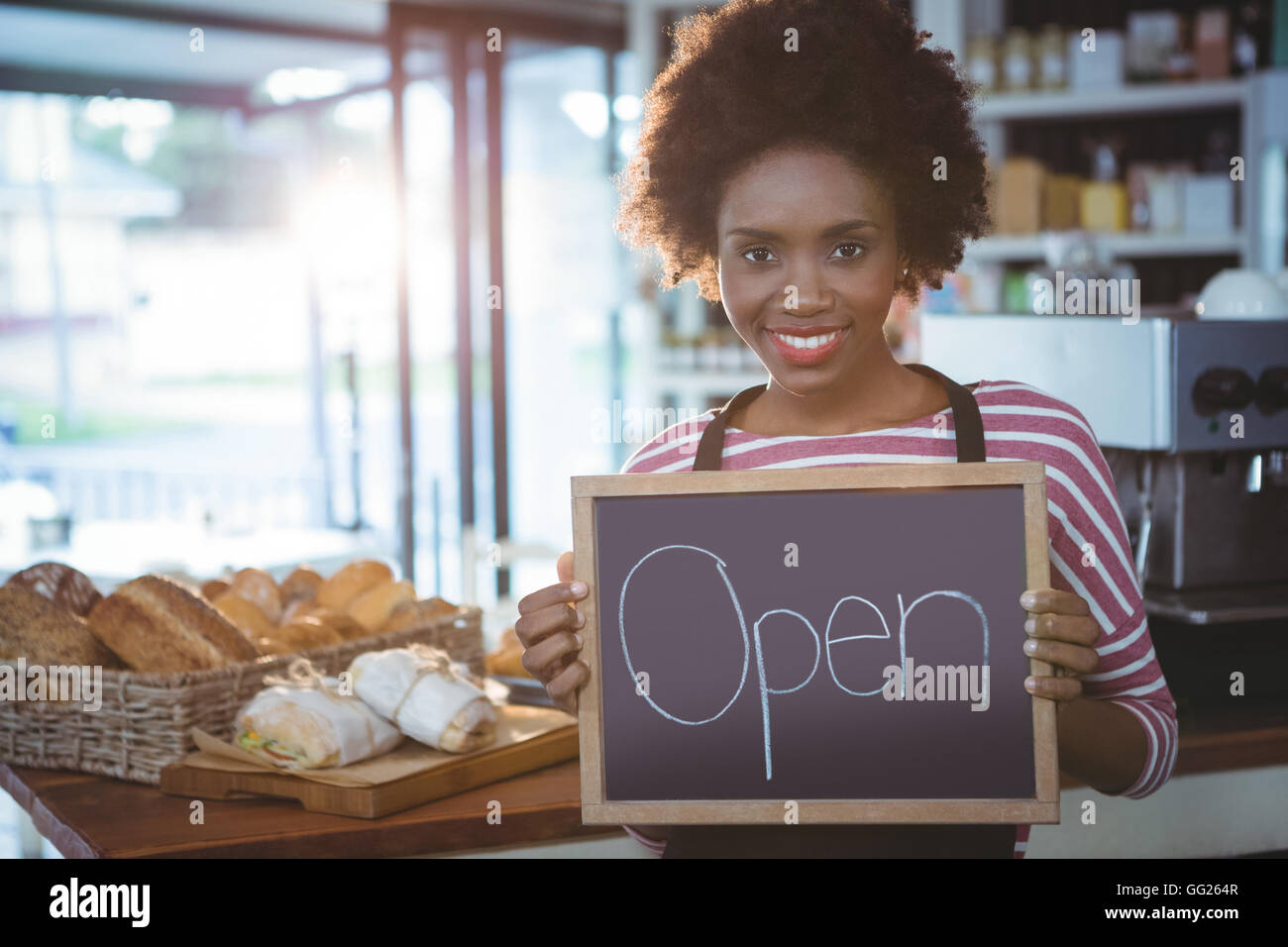 Waitress showing chalkboard open sign hi-res stock photography and ...