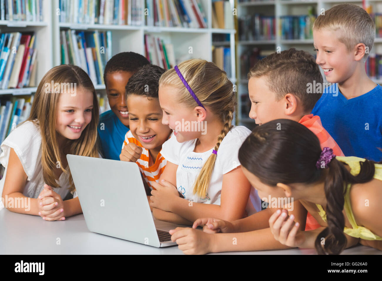 School kids using laptop in library Stock Photo - Alamy
