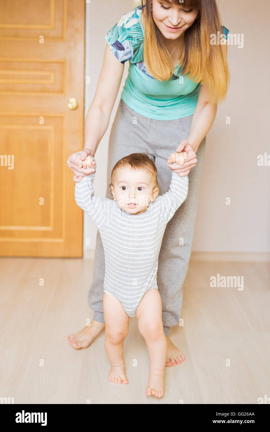 little child baby smiling making first steps Stock Photo - Alamy