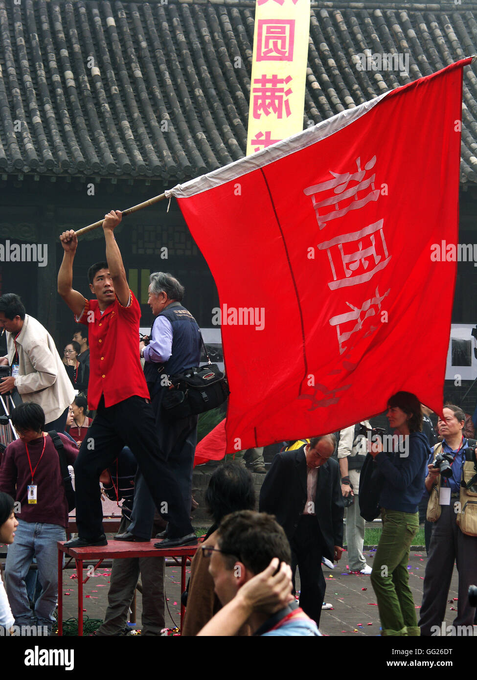 Man waving a flag at the Opening Ceremony of the Pingyao Photography ...
