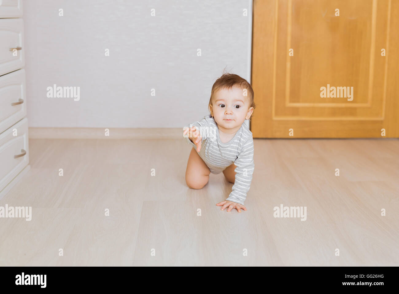 Happy crawling baby boy Stock Photo - Alamy