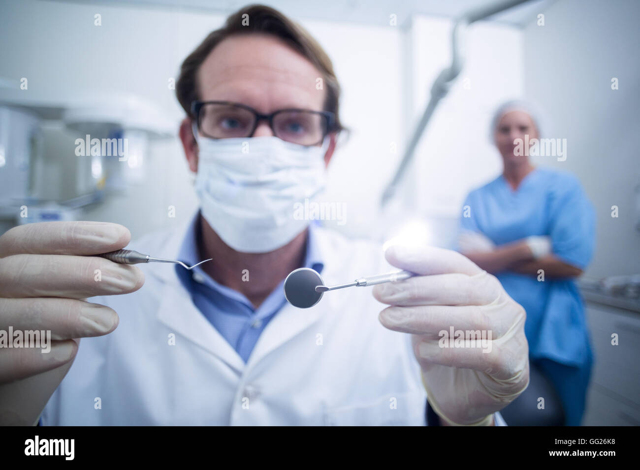Dentist holding dental tools Stock Photo - Alamy