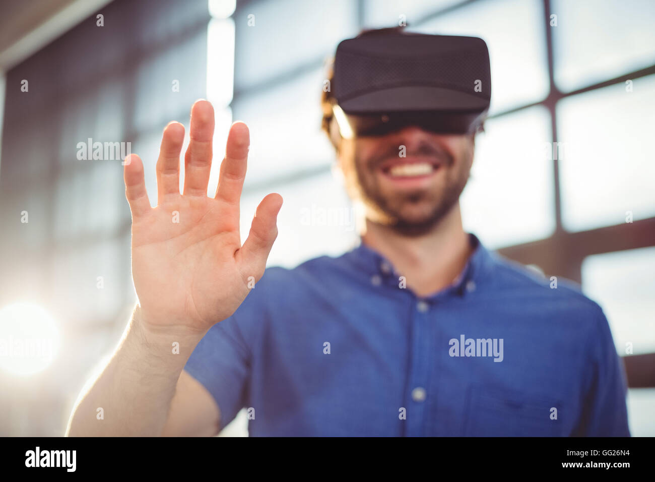 Male business executive using virtual reality headset Stock Photo - Alamy