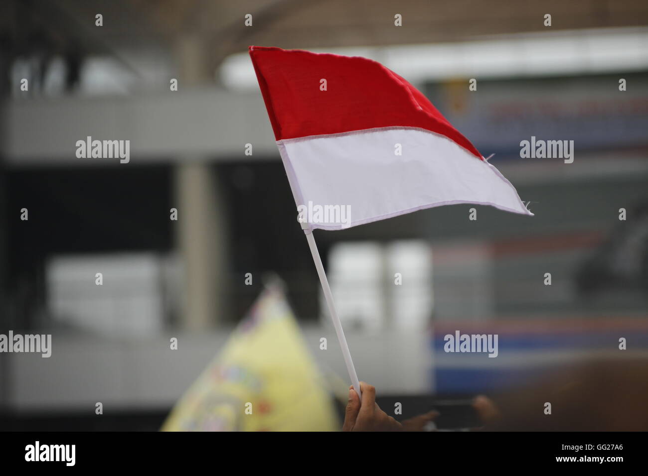 hand waving Indonesian flag Stock Photo - Alamy