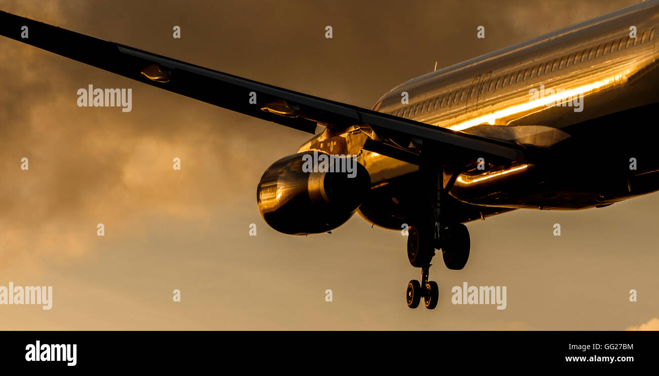 Passenger Aircraft Landing approach at sunset Stock Photo - Alamy