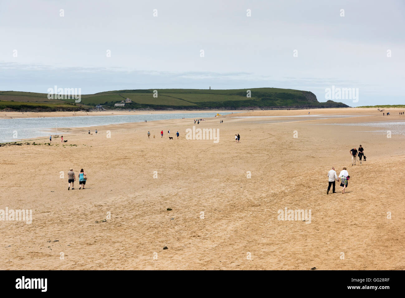 People walking on the beach at Daymer Bay on the River Camel estuary ...