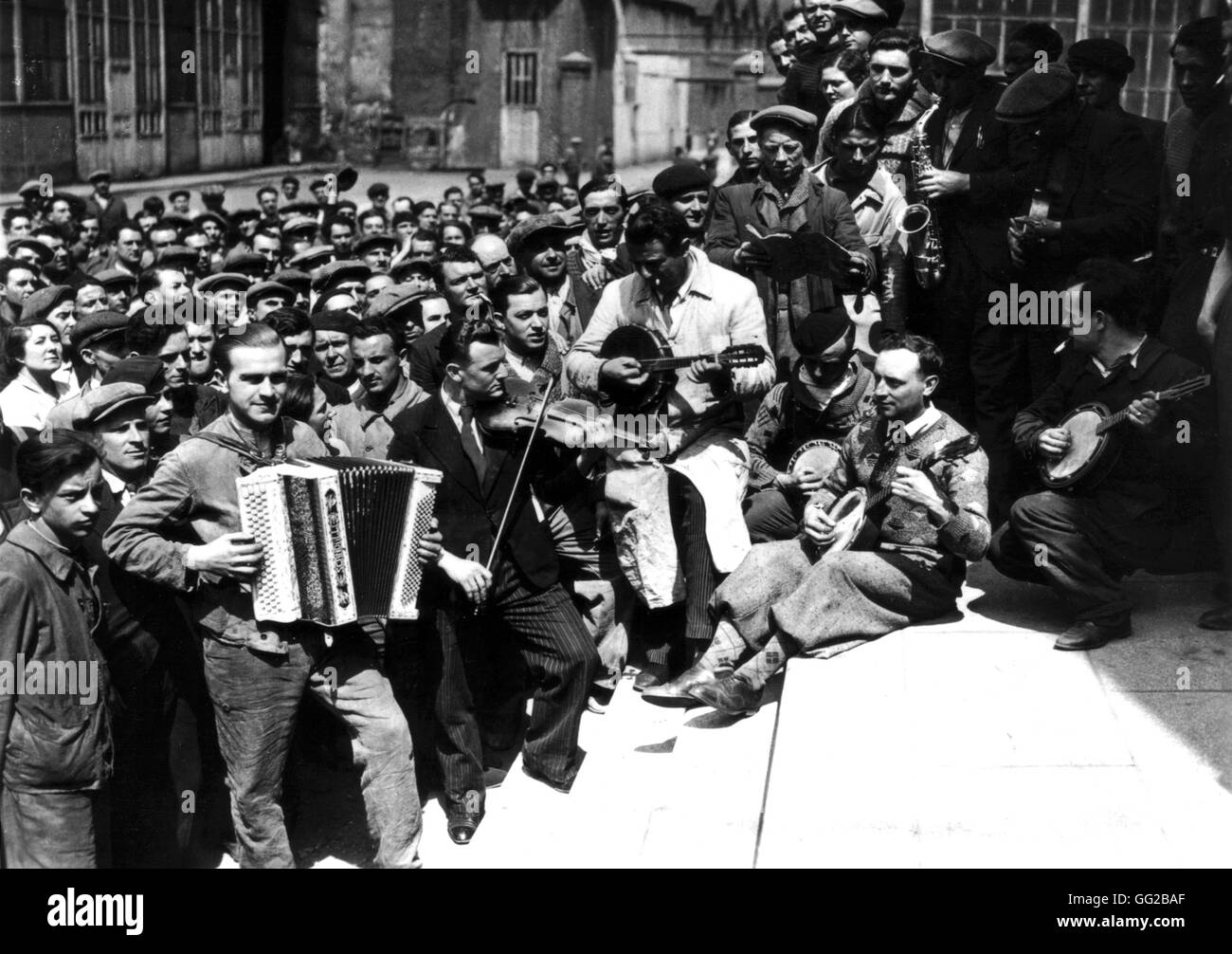 French strikers playing the accordion in the courtyard of their factory ...