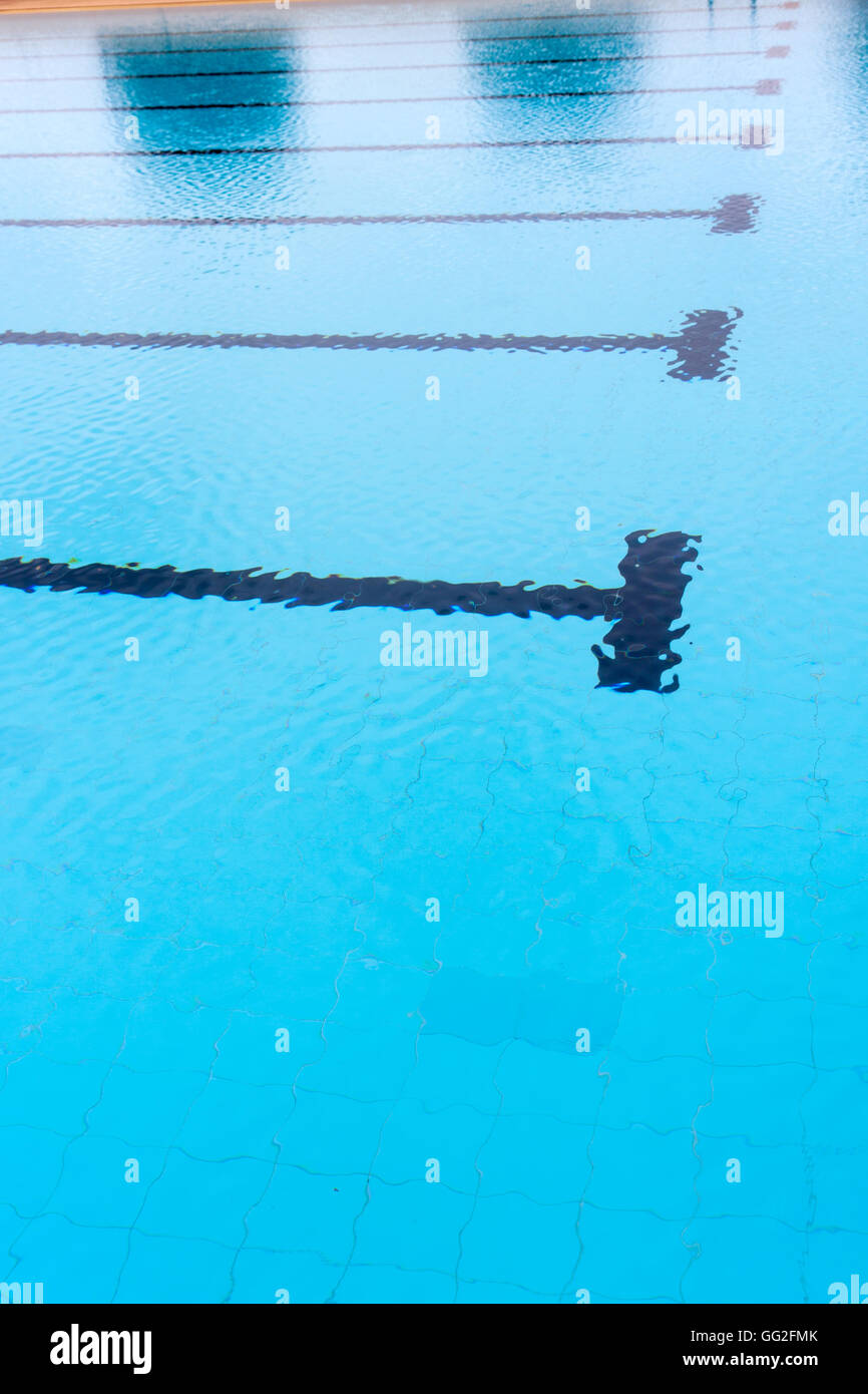 blue water wave in swimming pool reflects with sunlight , blue tile ...