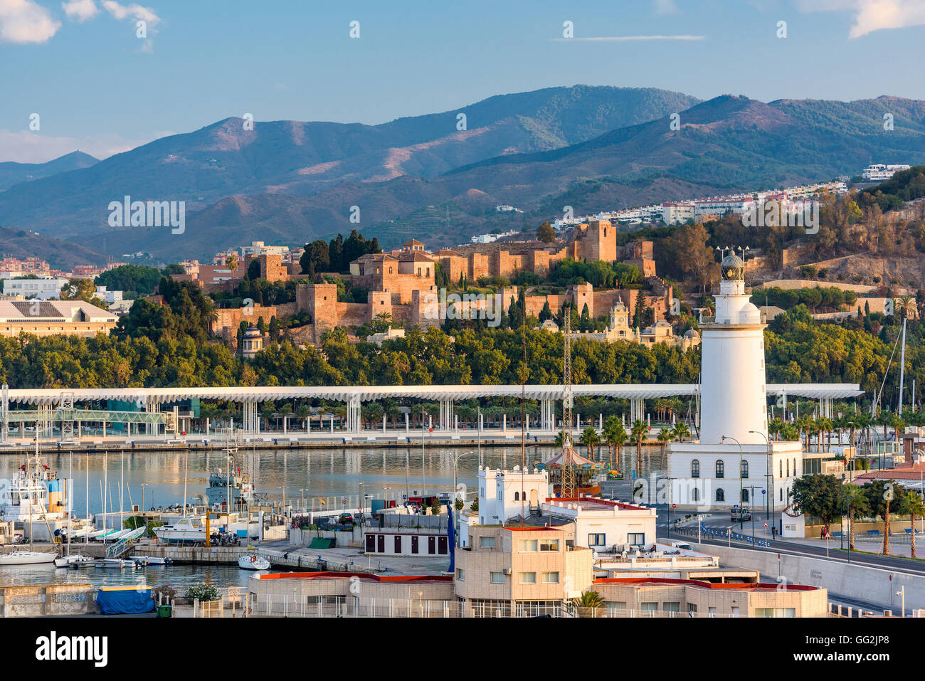 Malaga, Spain townscape with the lighthouse and Alcazaba Stock Photo ...