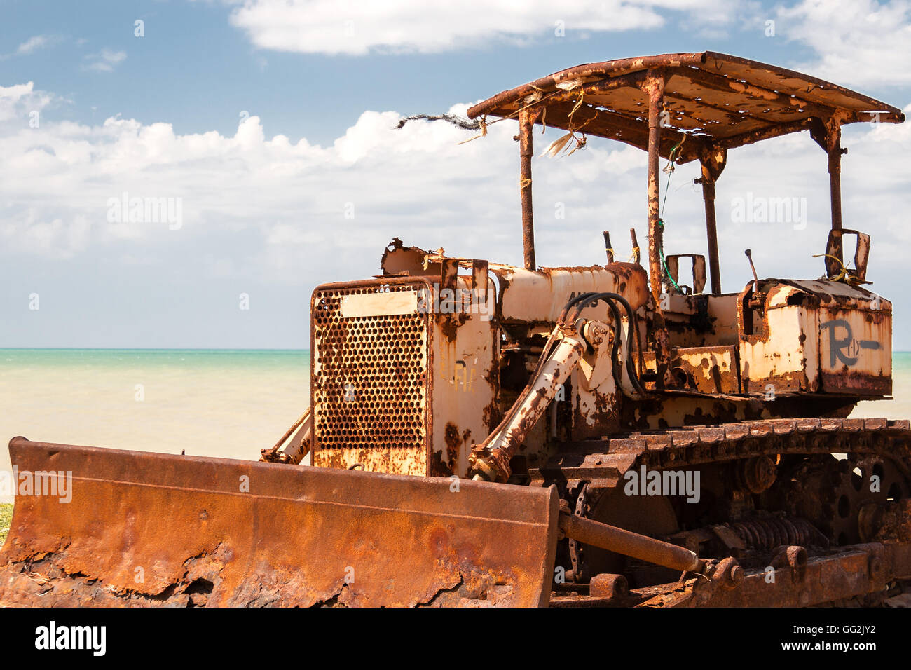Rusty abandoned backhoe next to the sea at La Guajira, Colombia Stock ...