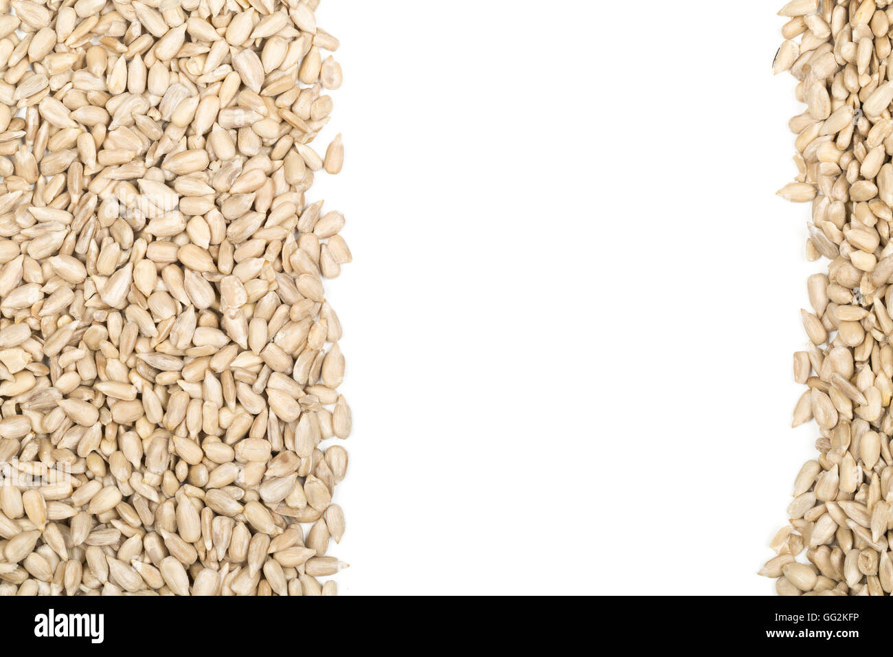 Unshelled natural sunflower seeds border over white background Stock ...