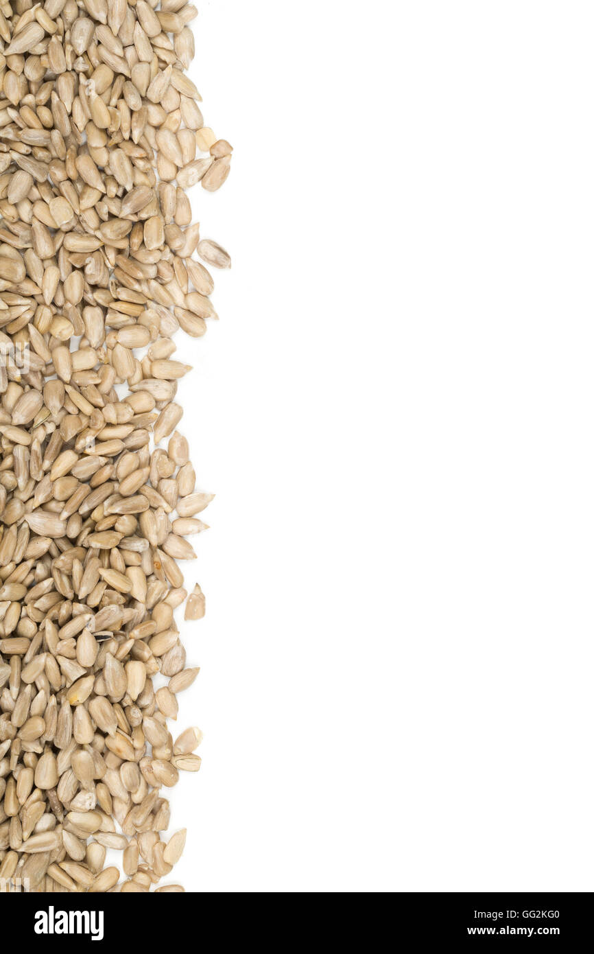 Unshelled natural sunflower seeds border over white background Stock ...
