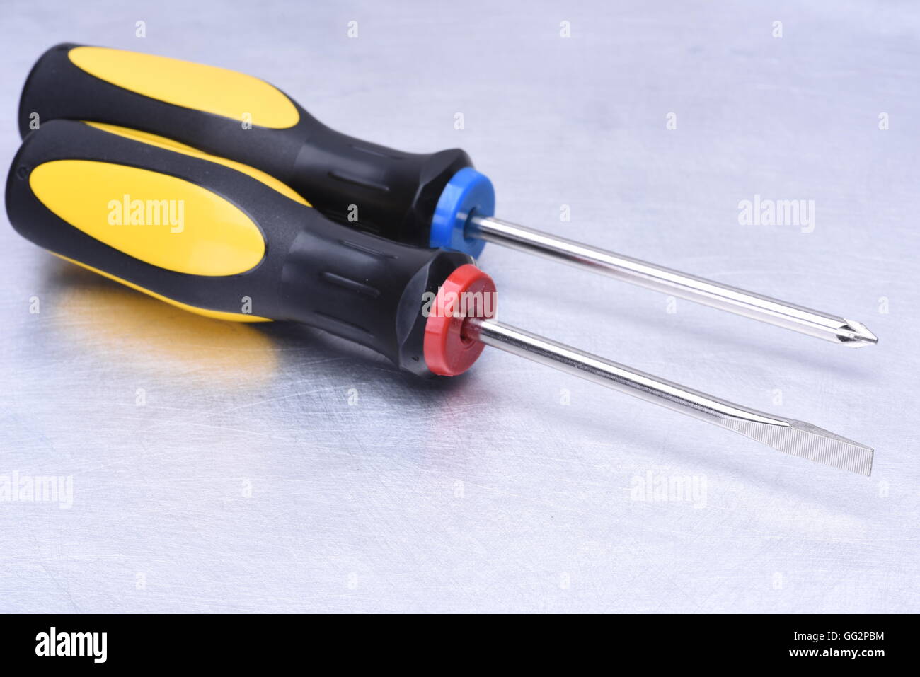 Two screwdrivers on metal background Stock Photo - Alamy