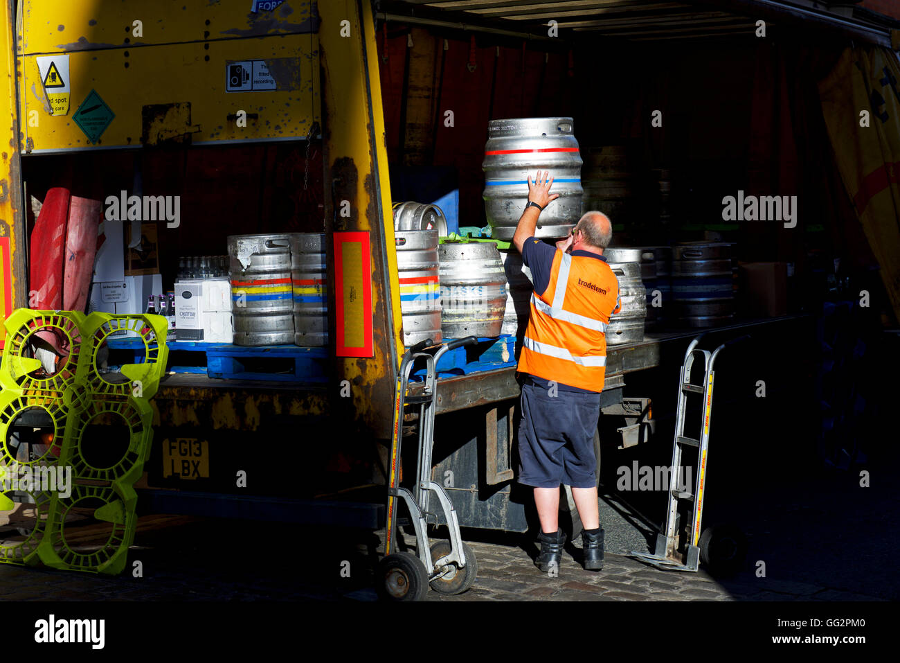 Man loading beer barrels onto lorry, York, North Yorkshire UK Stock ...