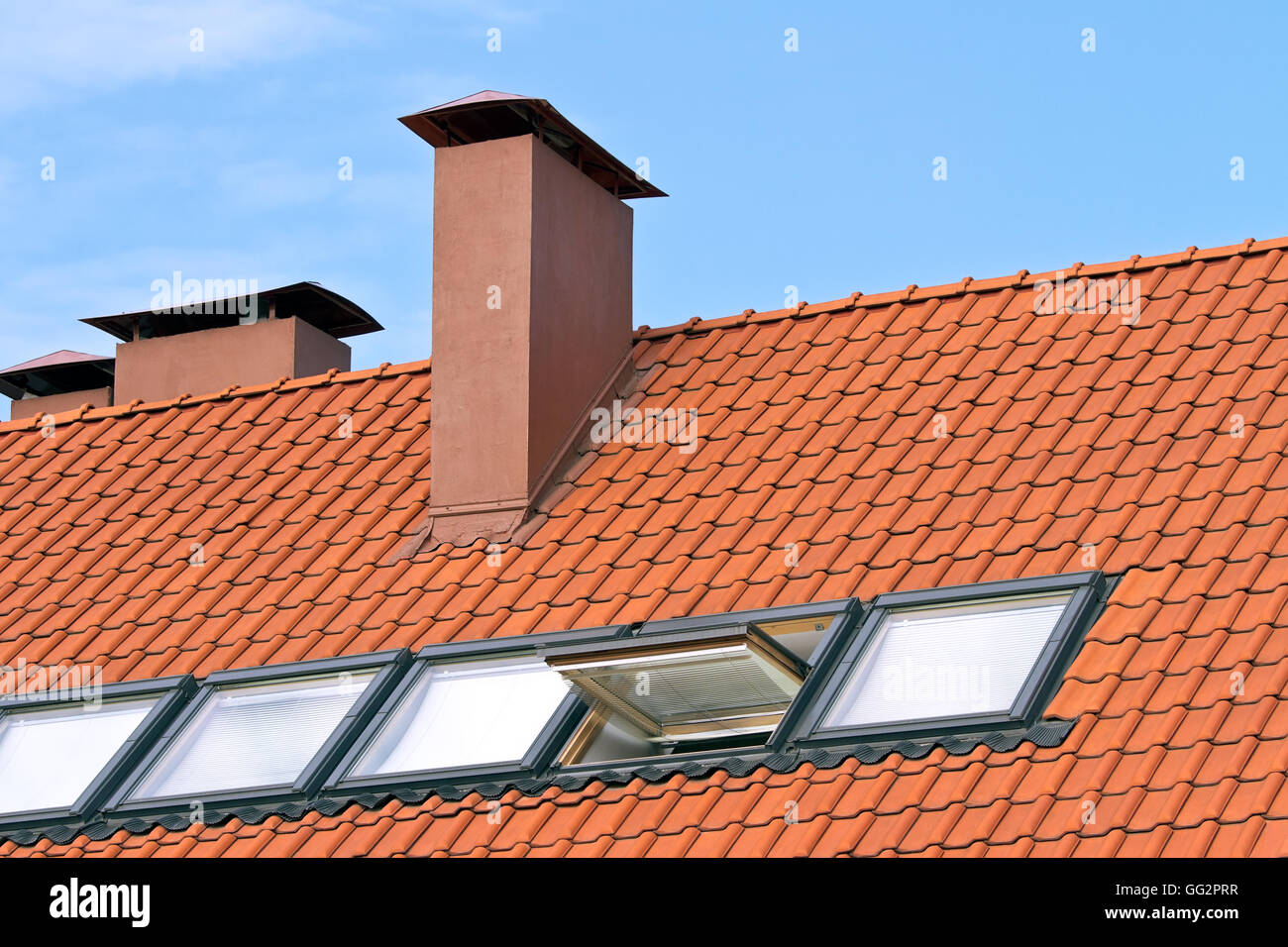 Tiled roof with a windows and chimney Stock Photo - Alamy