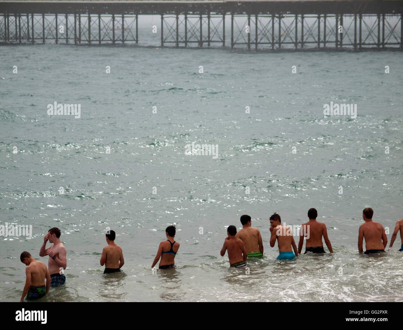 Lots of people having fun in the sea and on the beach in Brighton Stock ...