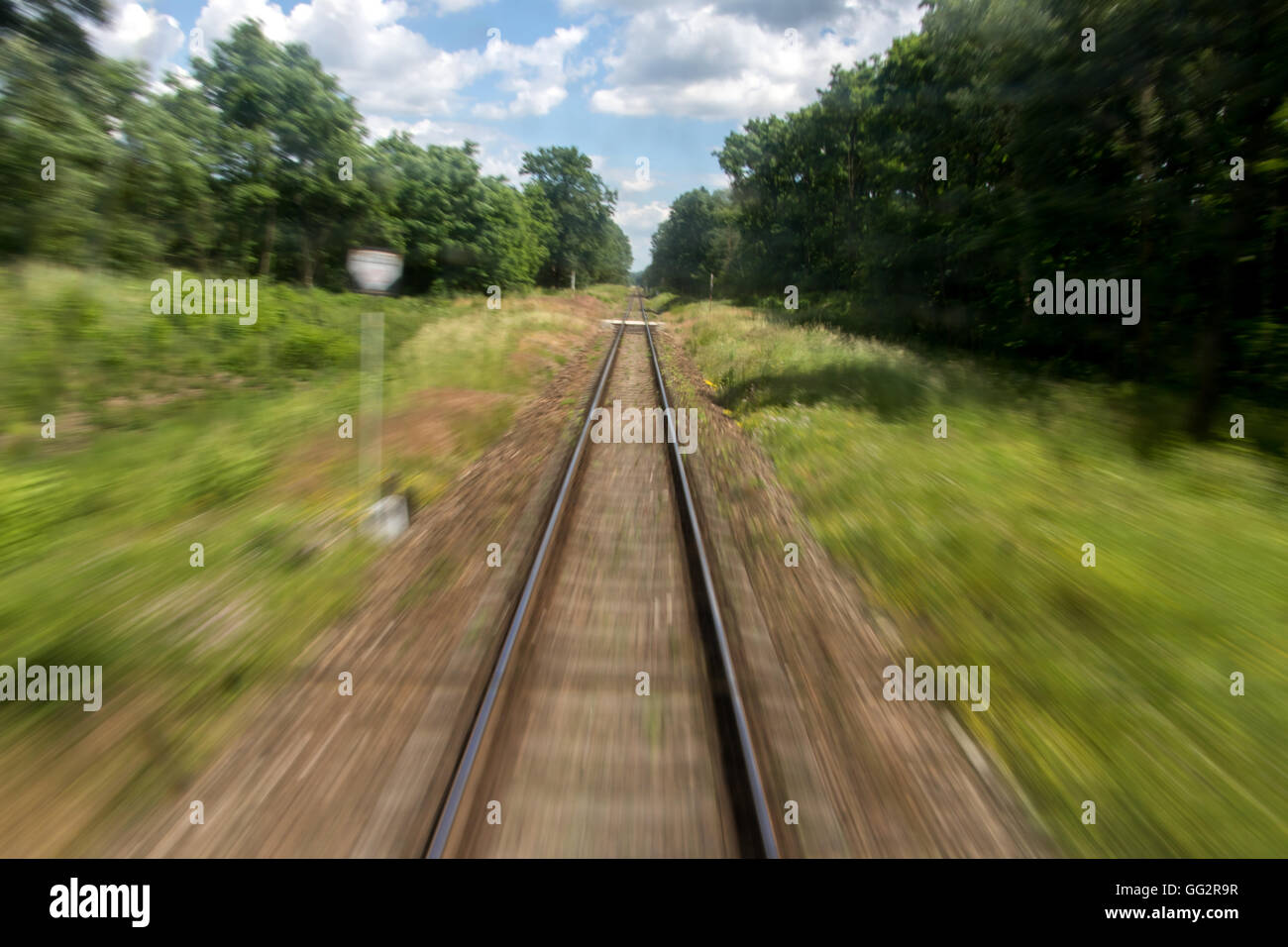 Defocused railroad tracks in summer nature behind a passing train Stock ...